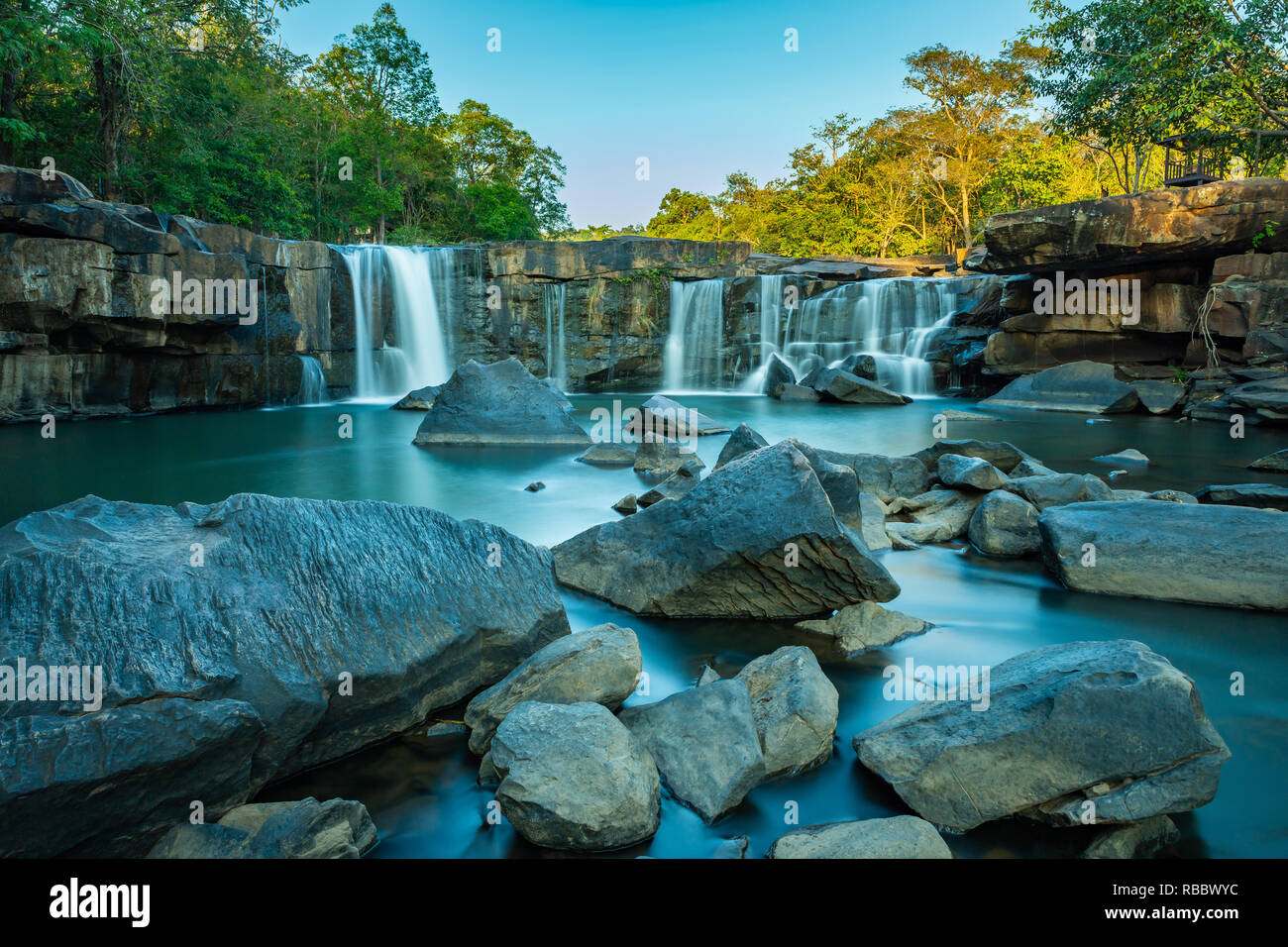 Water cascading from small cliff of Tad Tone waterfall with misty water ...