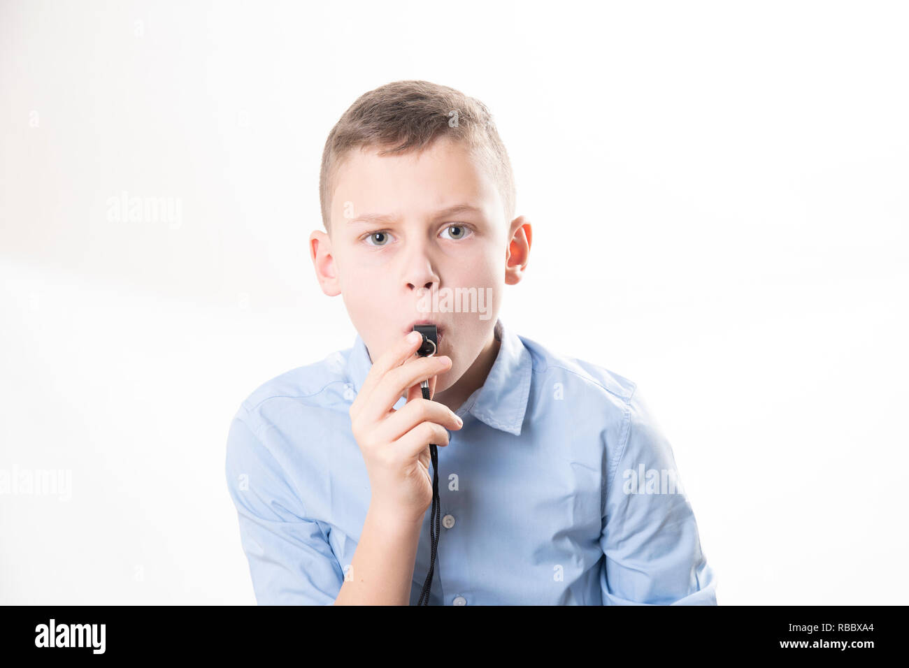 Boy with whistle on white background Stock Photo - Alamy