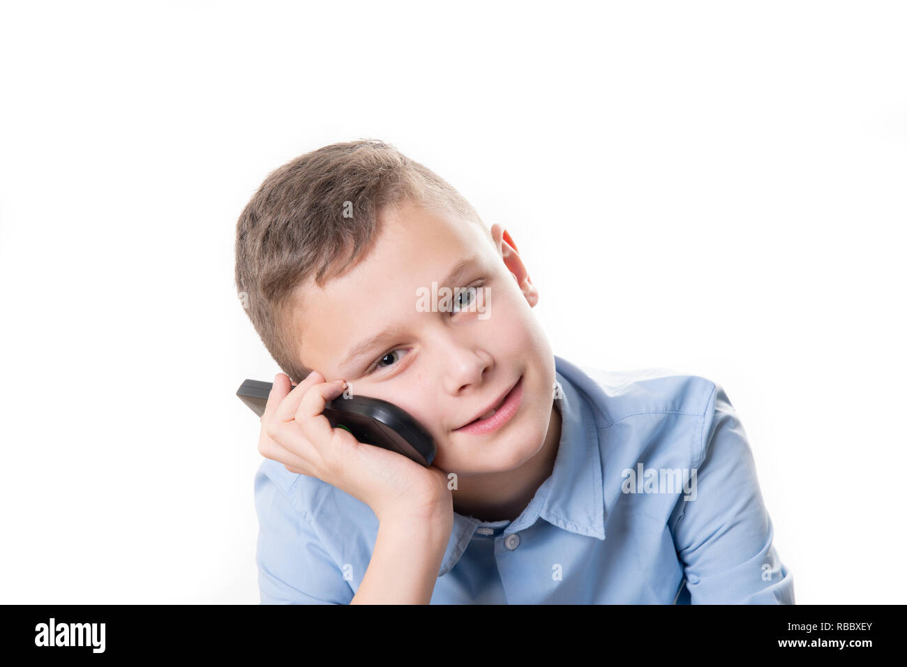 Boy with a blue shirt on the phone with an old big cell phone Stock ...
