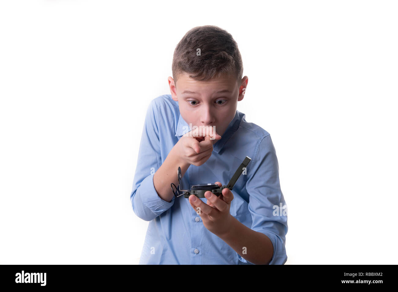 Boy recognizes on a compass in his hand the right direction for the ...
