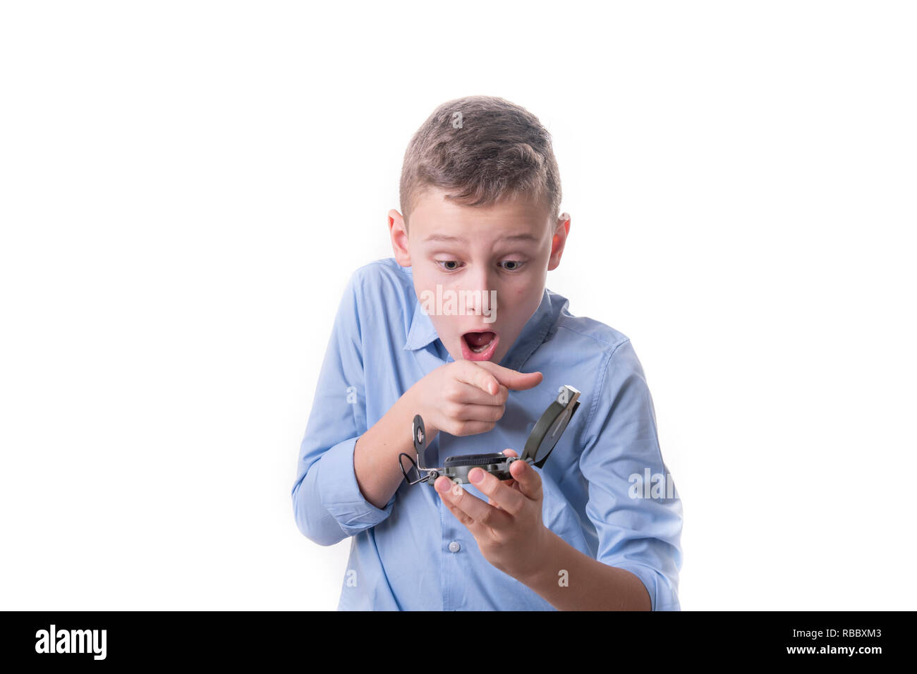 Boy recognizes on a compass in his hand the right direction for the ...