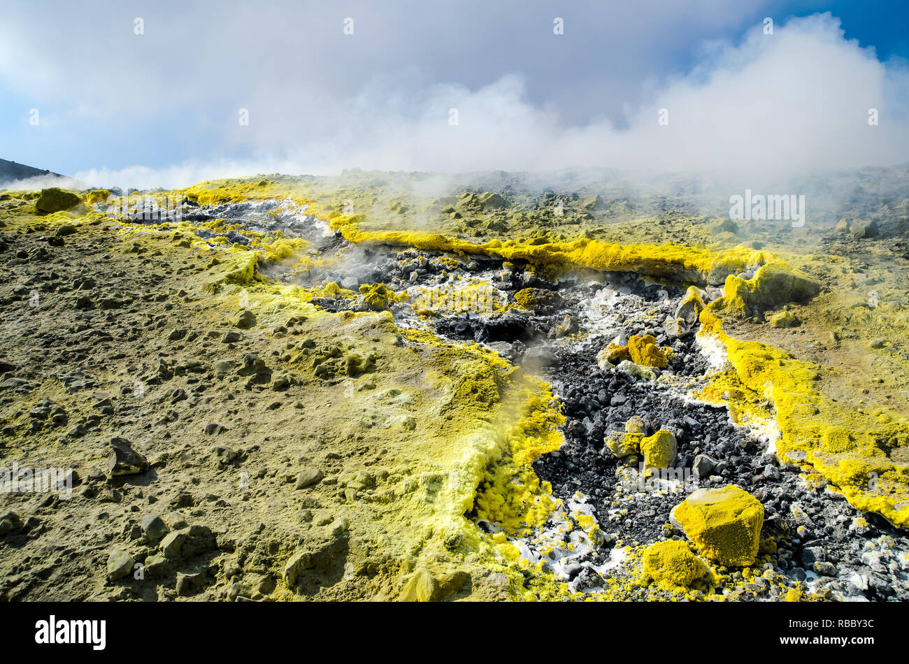Yellow Sulphur crystals on surface rocks of a volcano crater on the ...