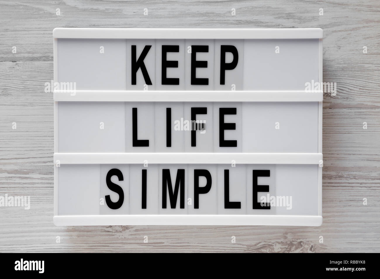 'Keep life simple' words on modern board over white wooden background ...