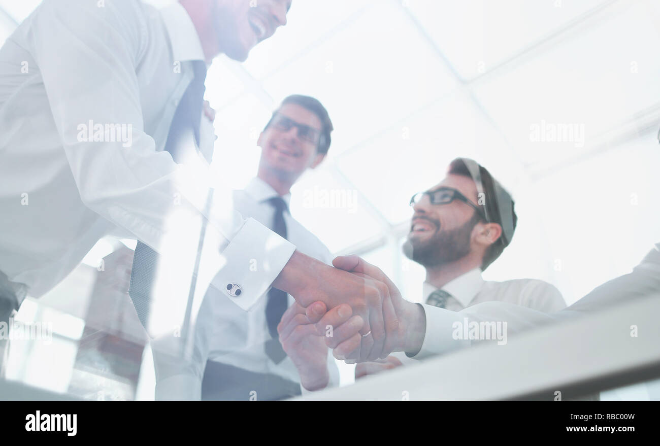 bottom view. handshake employees over the Desk Stock Photo - Alamy