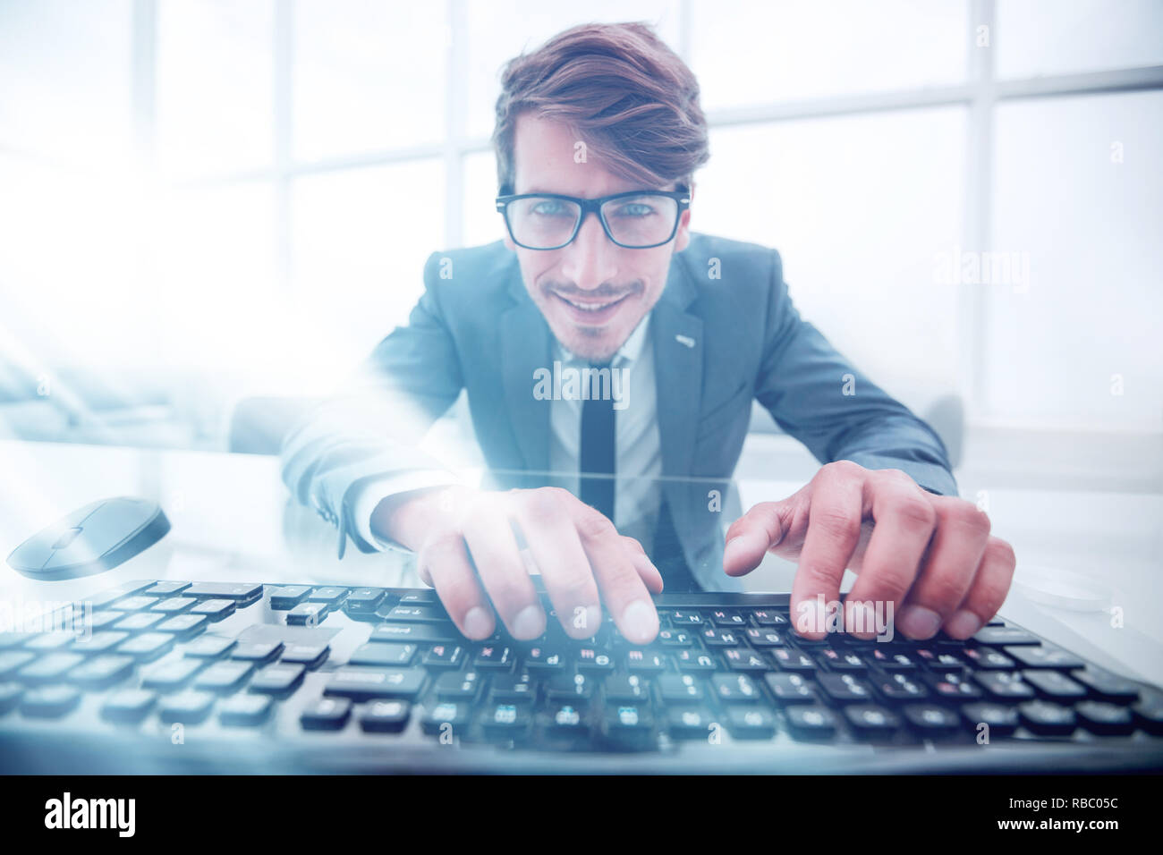 young man using keyboard , closely and carefully looking at the Stock ...