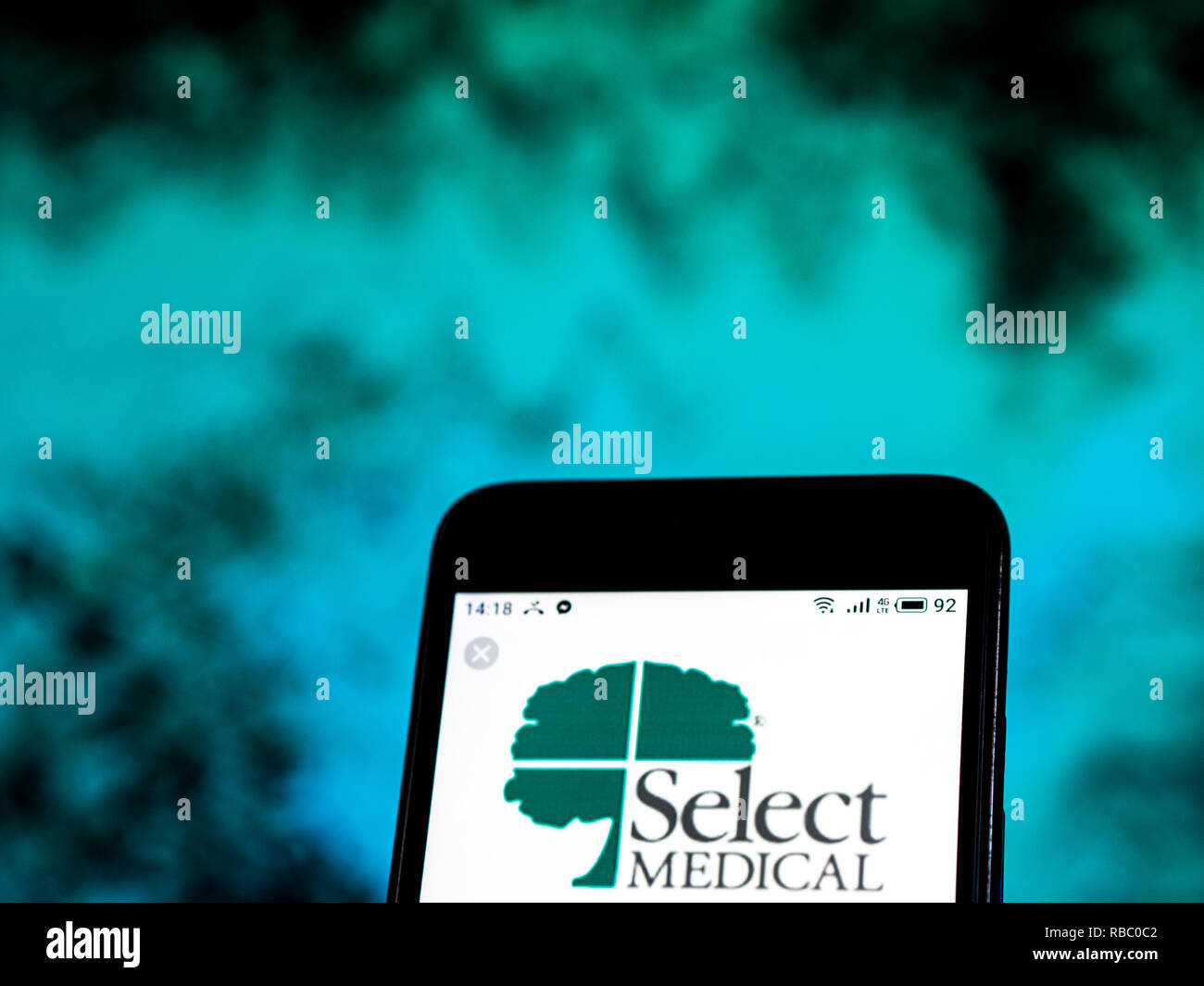 Select Medical Healthcare company logo seen displayed on smart phone ... Select Medical Healthcare company logo seen displayed on smart phone ...
