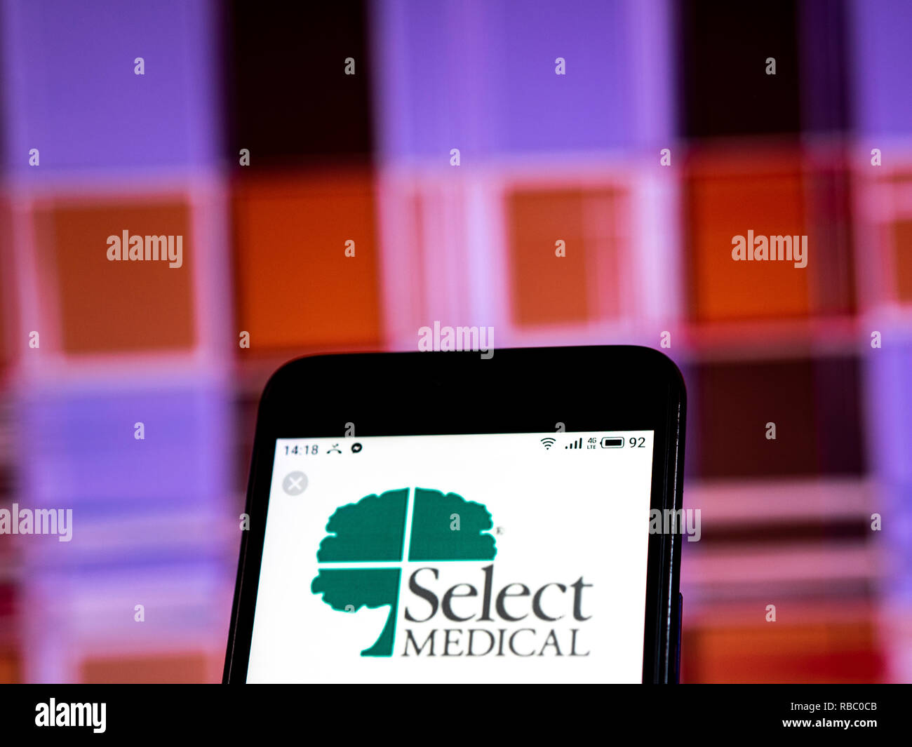 Select Medical Healthcare company logo seen displayed on smart phone ... Select Medical Healthcare company logo seen displayed on smart phone ...