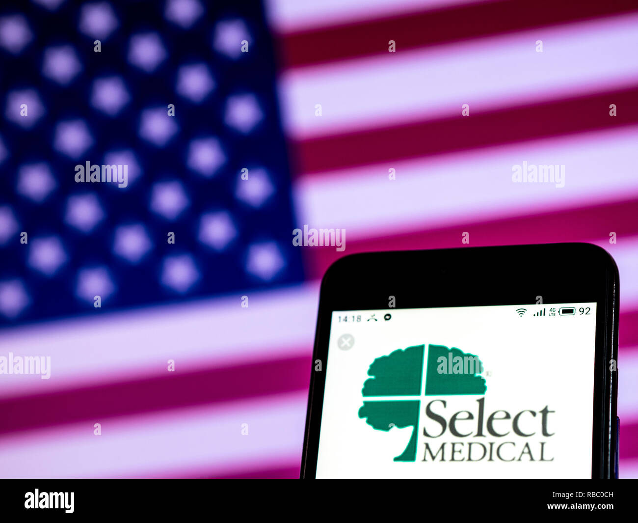 Select Medical Healthcare company logo seen displayed on smart phone ... Select Medical Healthcare company logo seen displayed on smart phone ...