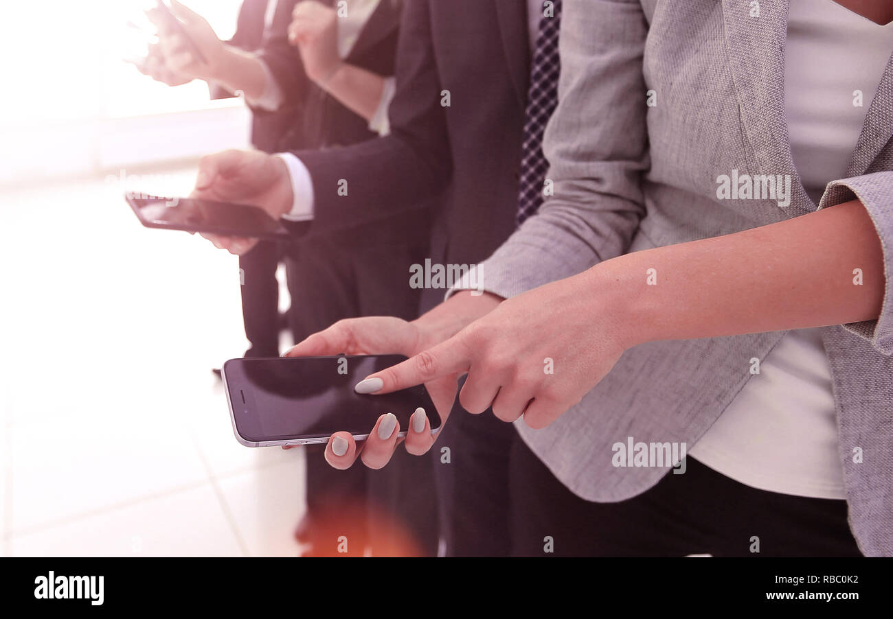 closeup.a group of employees with smartphones Stock Photo - Alamy
