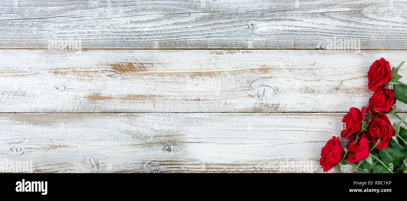 Romantic red roses on white rustic wooden background Stock Photo - Alamy