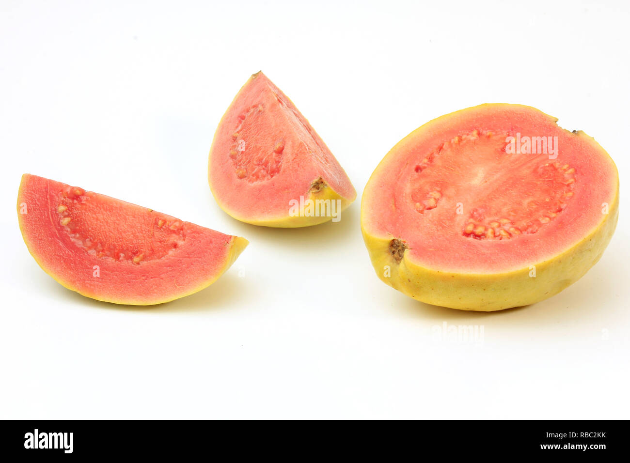close-up guava fruit, pink, fresh, organic, with leaves, whole and ...