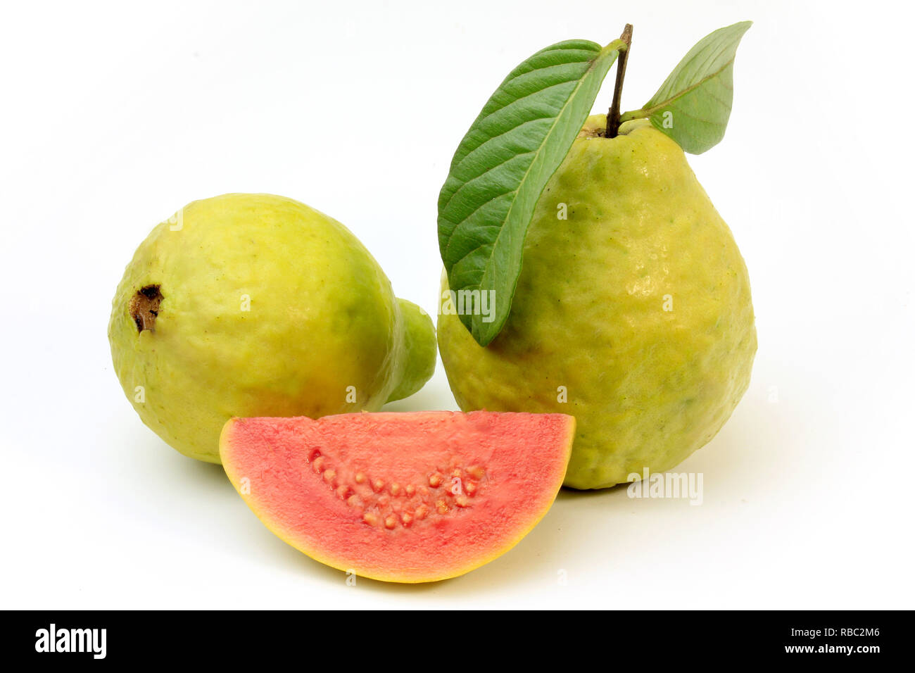 close-up guava fruit, pink, fresh, organic, with leaves, whole and ...
