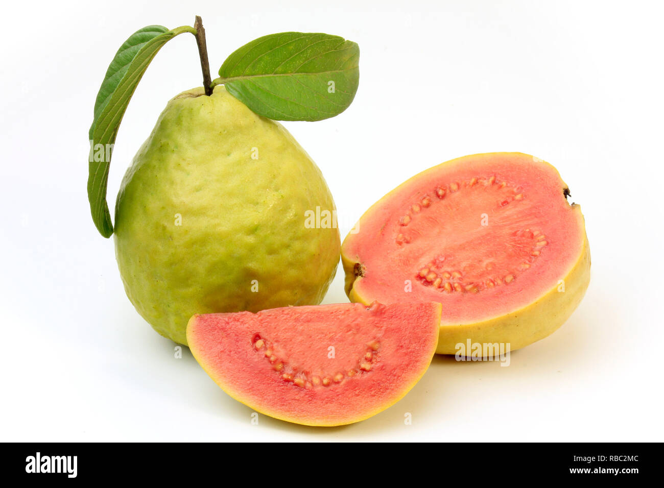 close-up guava fruit, pink, fresh, organic, with leaves, whole and ...