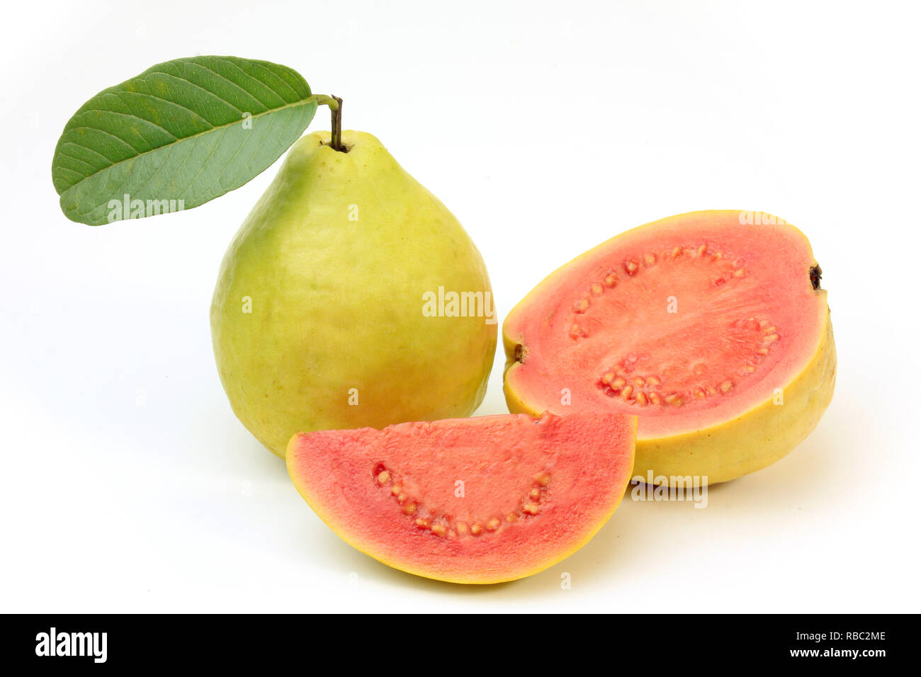 close-up guava fruit, pink, fresh, organic, with leaves, whole and ...