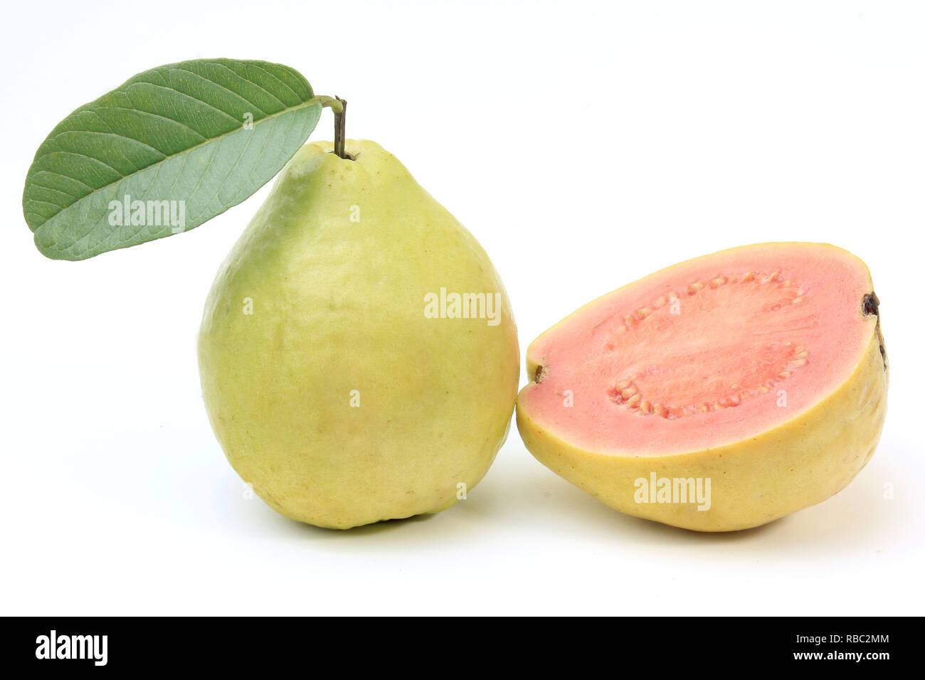 close-up guava fruit, pink, fresh, organic, with leaves, whole and ...
