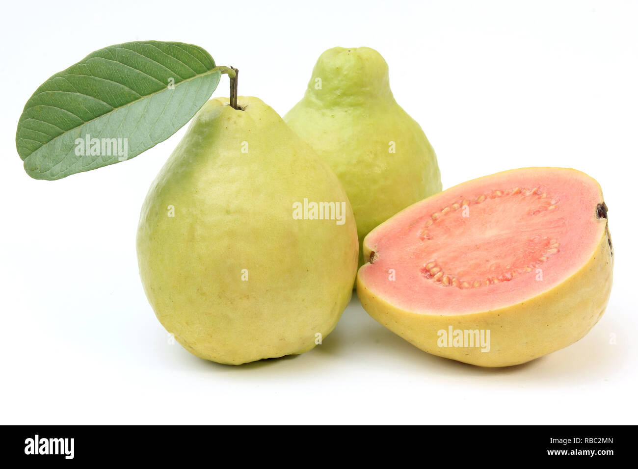 close-up guava fruit, pink, fresh, organic, with leaves, whole and ...
