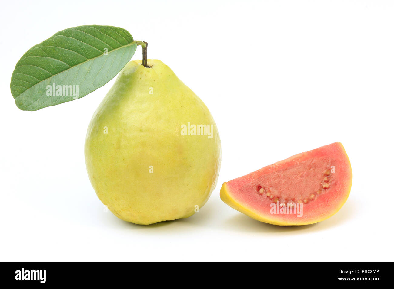 close-up guava fruit, pink, fresh, organic, with leaves, whole and ...