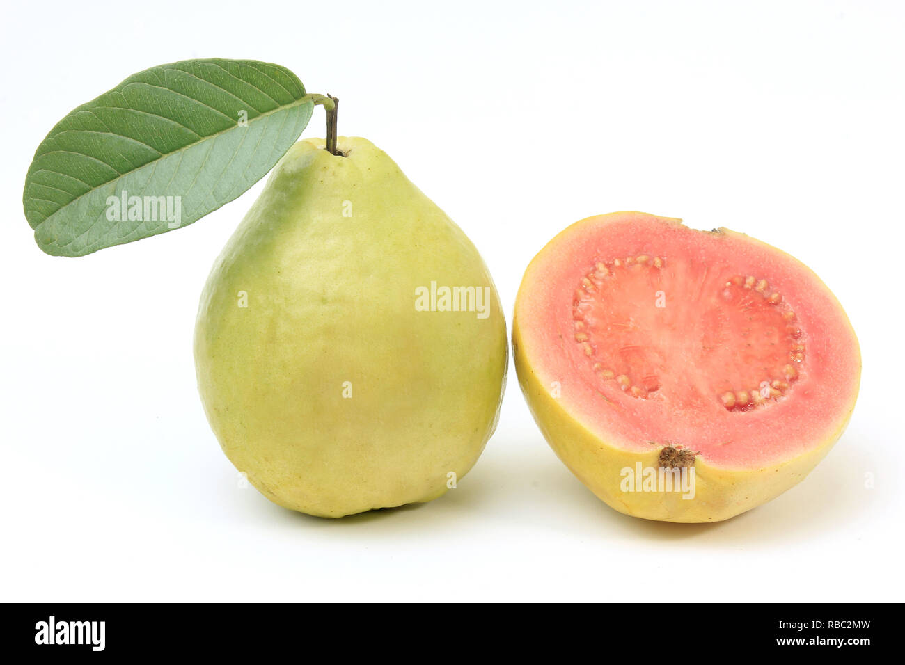 close-up guava fruit, pink, fresh, organic, with leaves, whole and ...