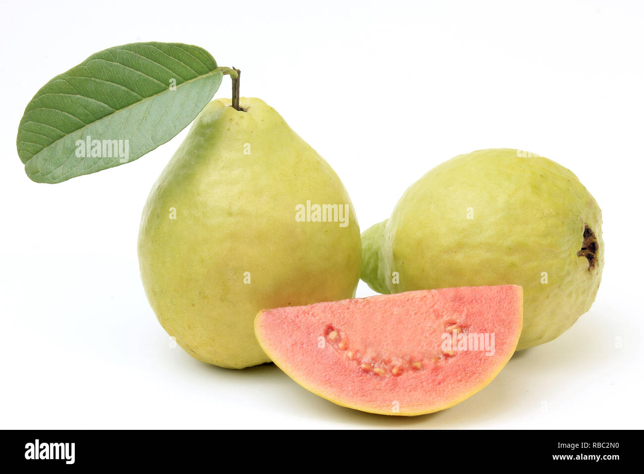 close-up guava fruit, pink, fresh, organic, with leaves, whole and ...