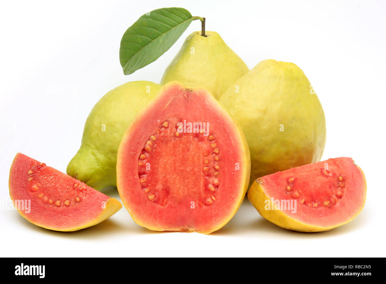 close-up guava fruit, pink, fresh, organic, with leaves, whole and ...