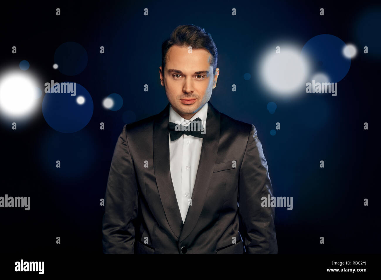 Professional showman wearing suit standing isolated on black background ...