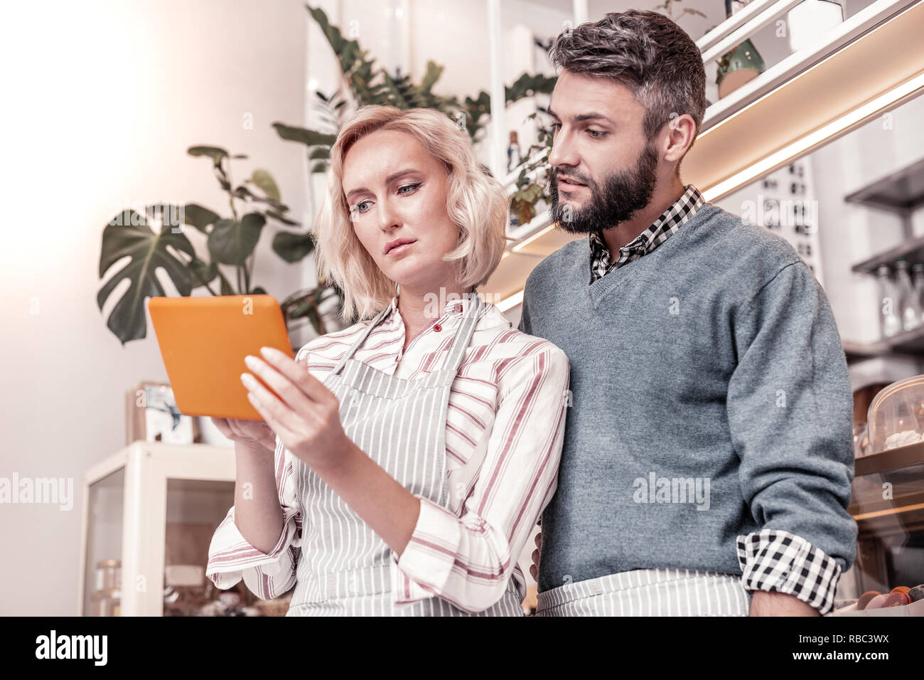 Nice young people looking at the tablet screen Stock Photo - Alamy