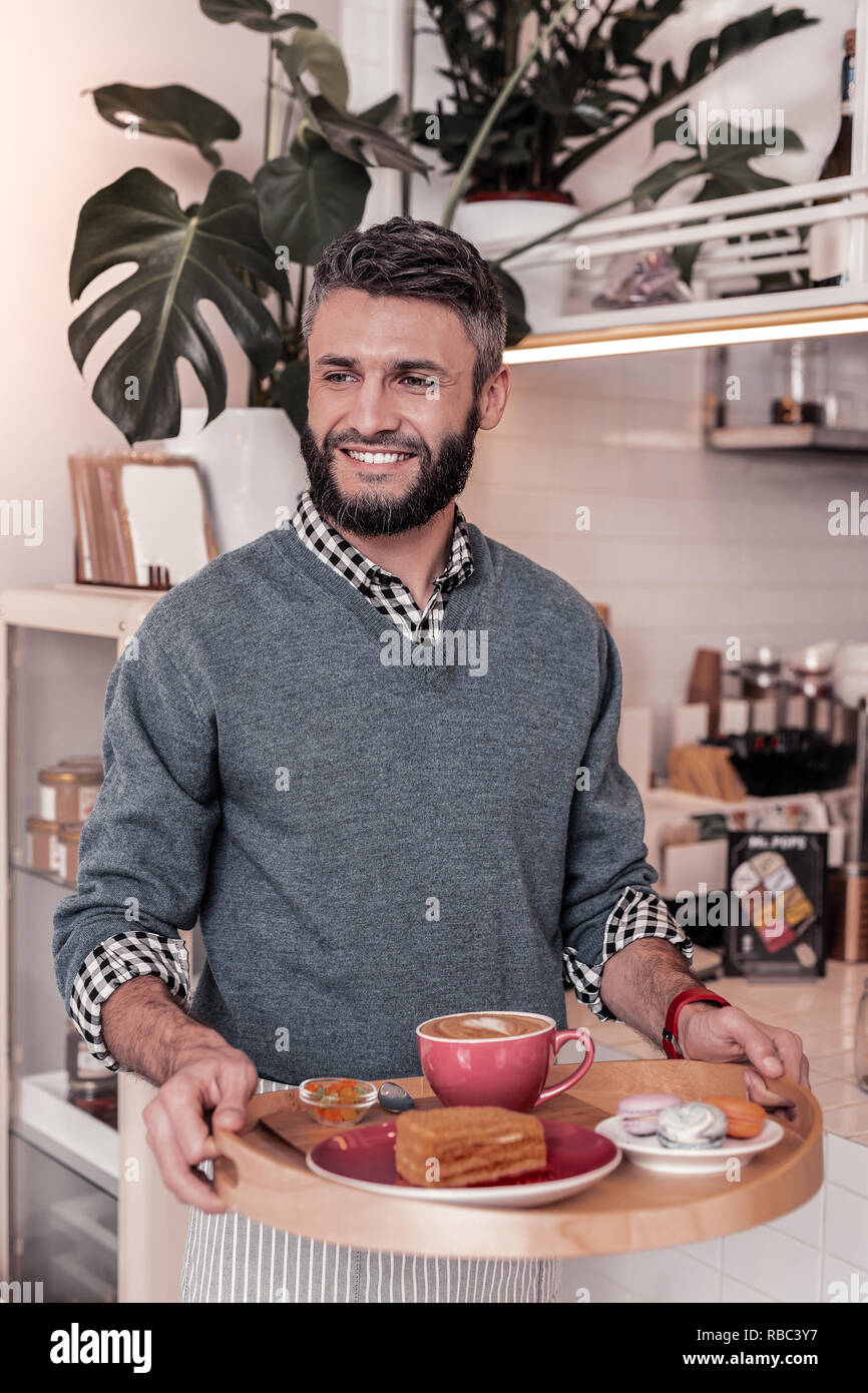 Positive joyful man working as a waiter Stock Photo - Alamy