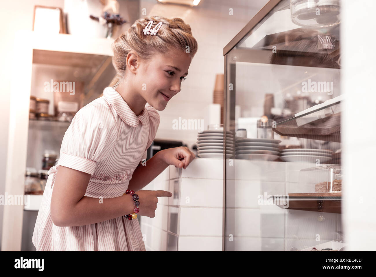 Happy delighted girl looking at the display Stock Photo - Alamy