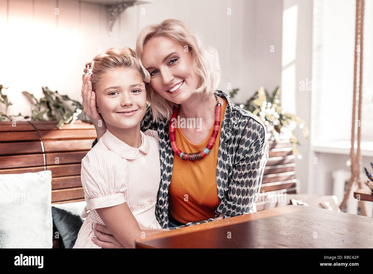 Joyful positive mother and daughter smiling to you Stock Photo - Alamy