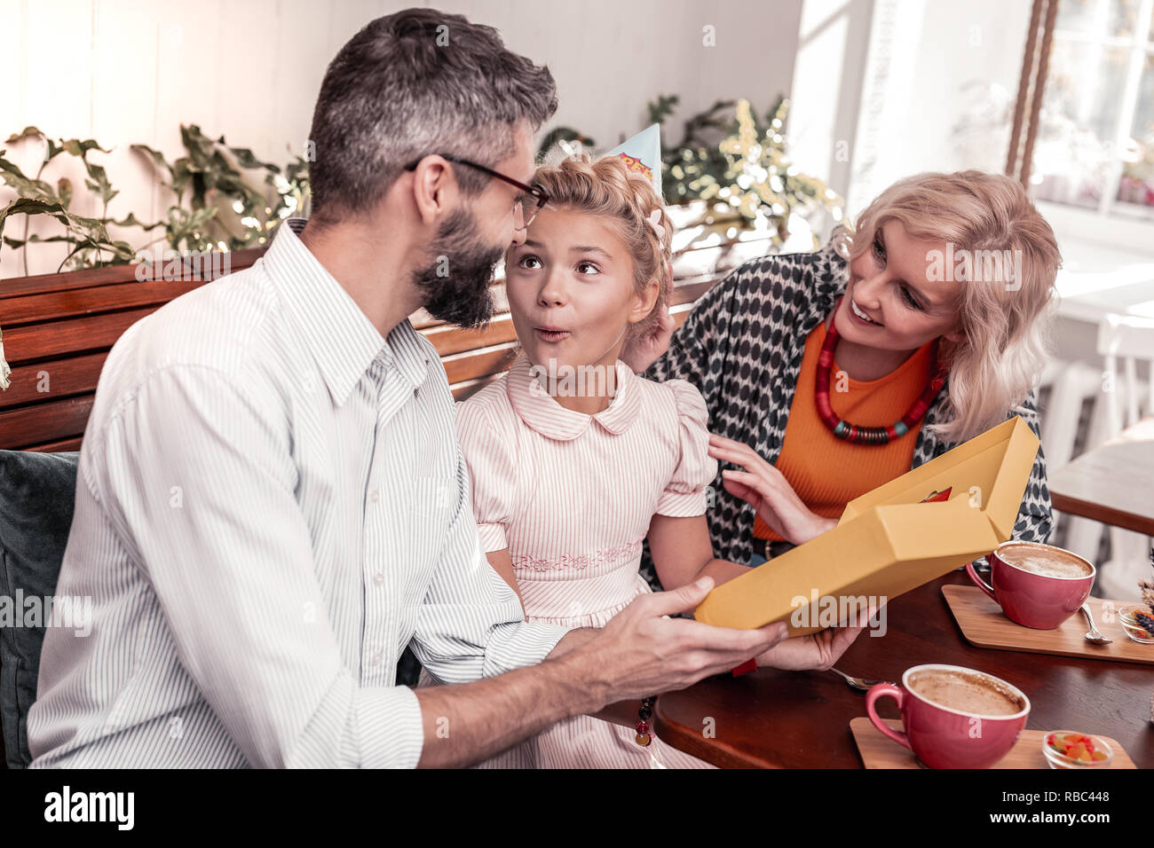 Positive excited girl being happy about the present Stock Photo - Alamy