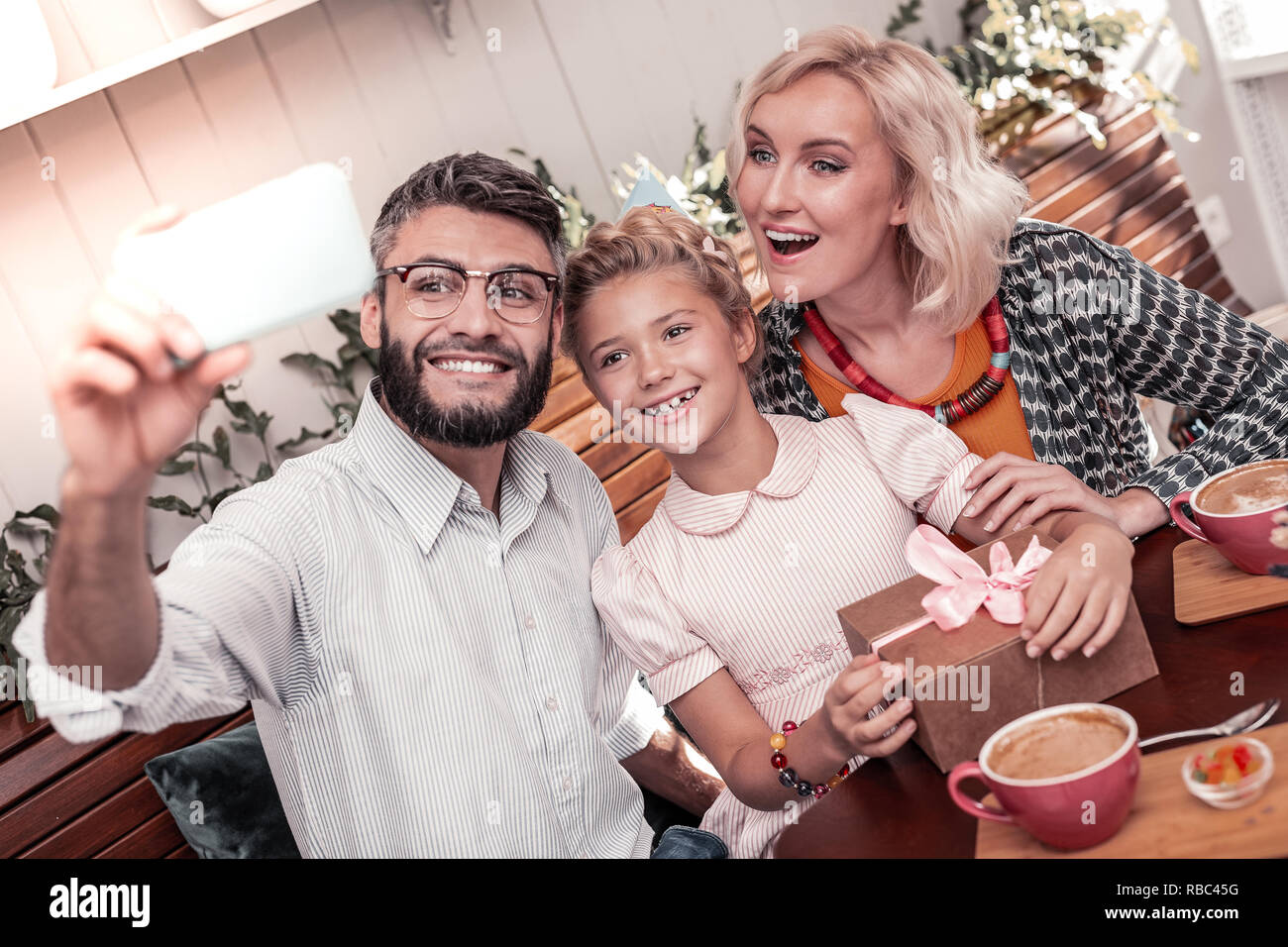 Joyful happy family looking into the camera Stock Photo - Alamy
