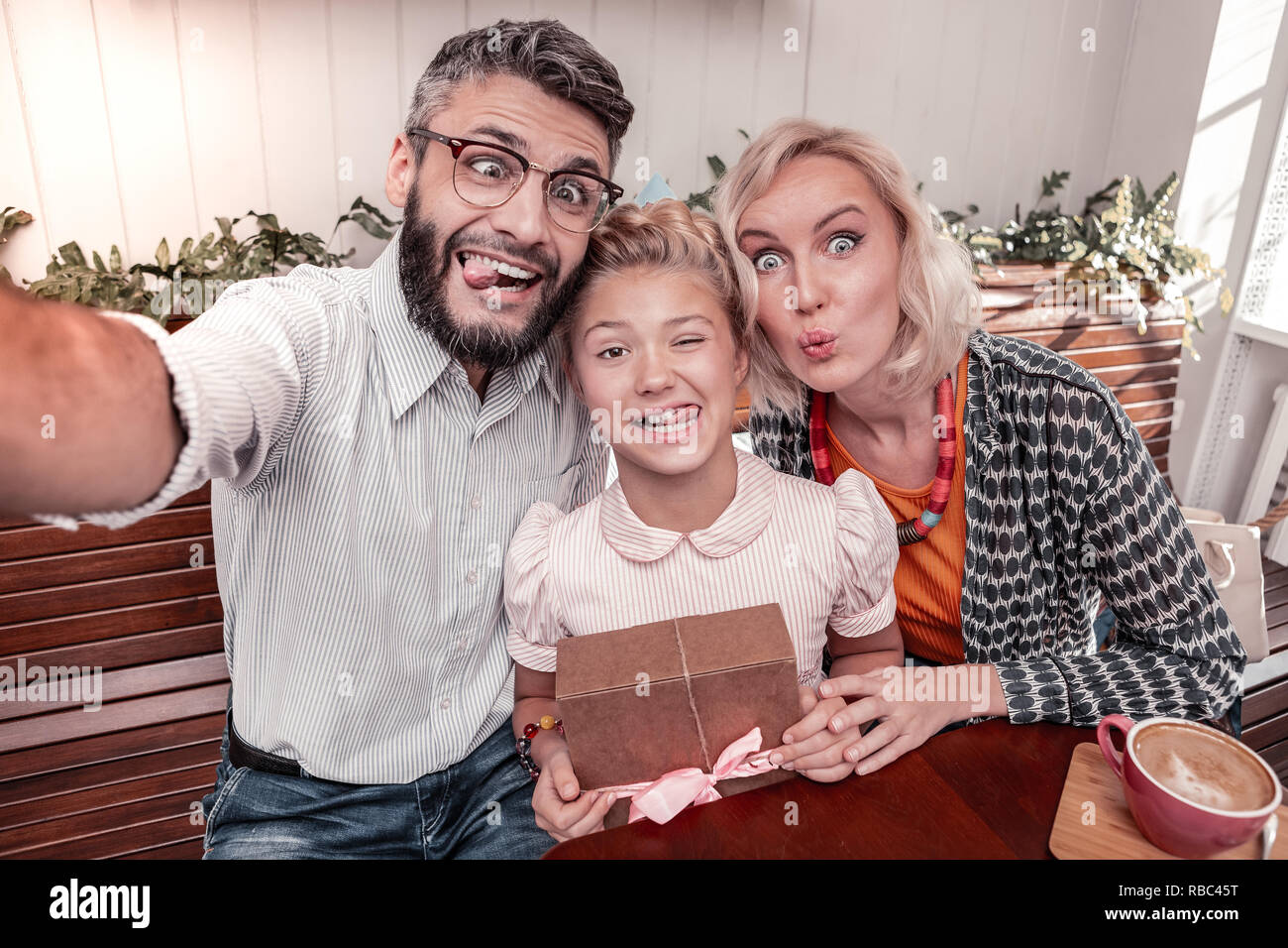 Joyful positive family taking a funny photo Stock Photo - Alamy