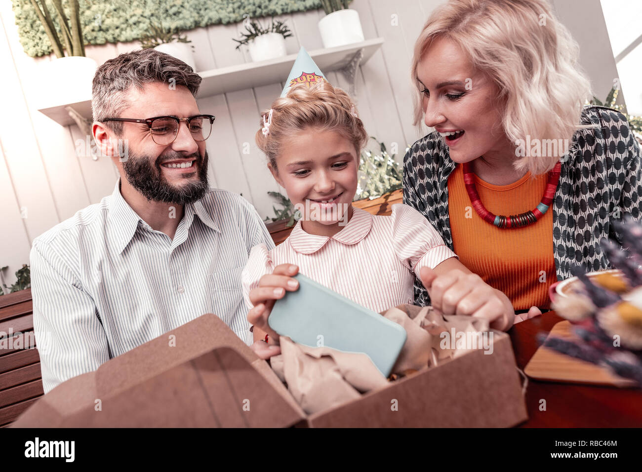 Positive nice girl receiving an expensive gift Stock Photo - Alamy