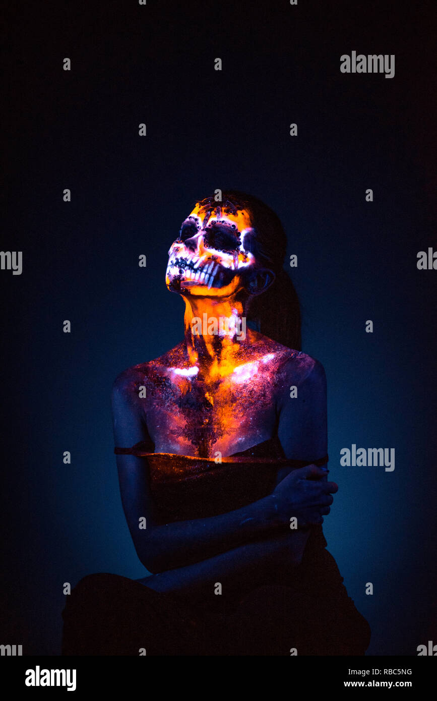 Girl's Face painted in fluorescent UV colors and looks like Neon ...