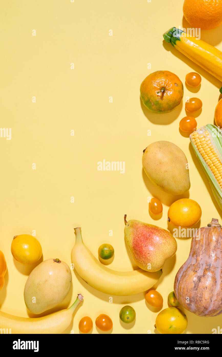 Collection of fresh yellow fruit and vegetables on the light yellow ...