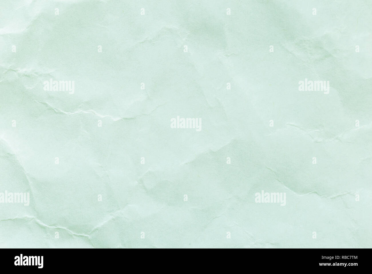 Crumpled green recycled paper background for business communication and ...