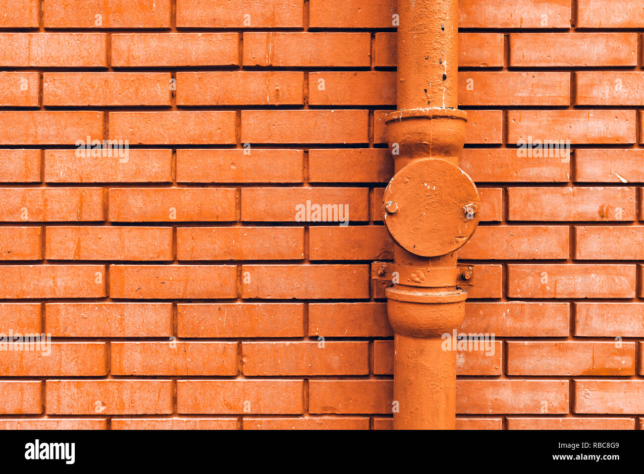 Gutter downpipe and brick wall as urban background Stock Photo - Alamy