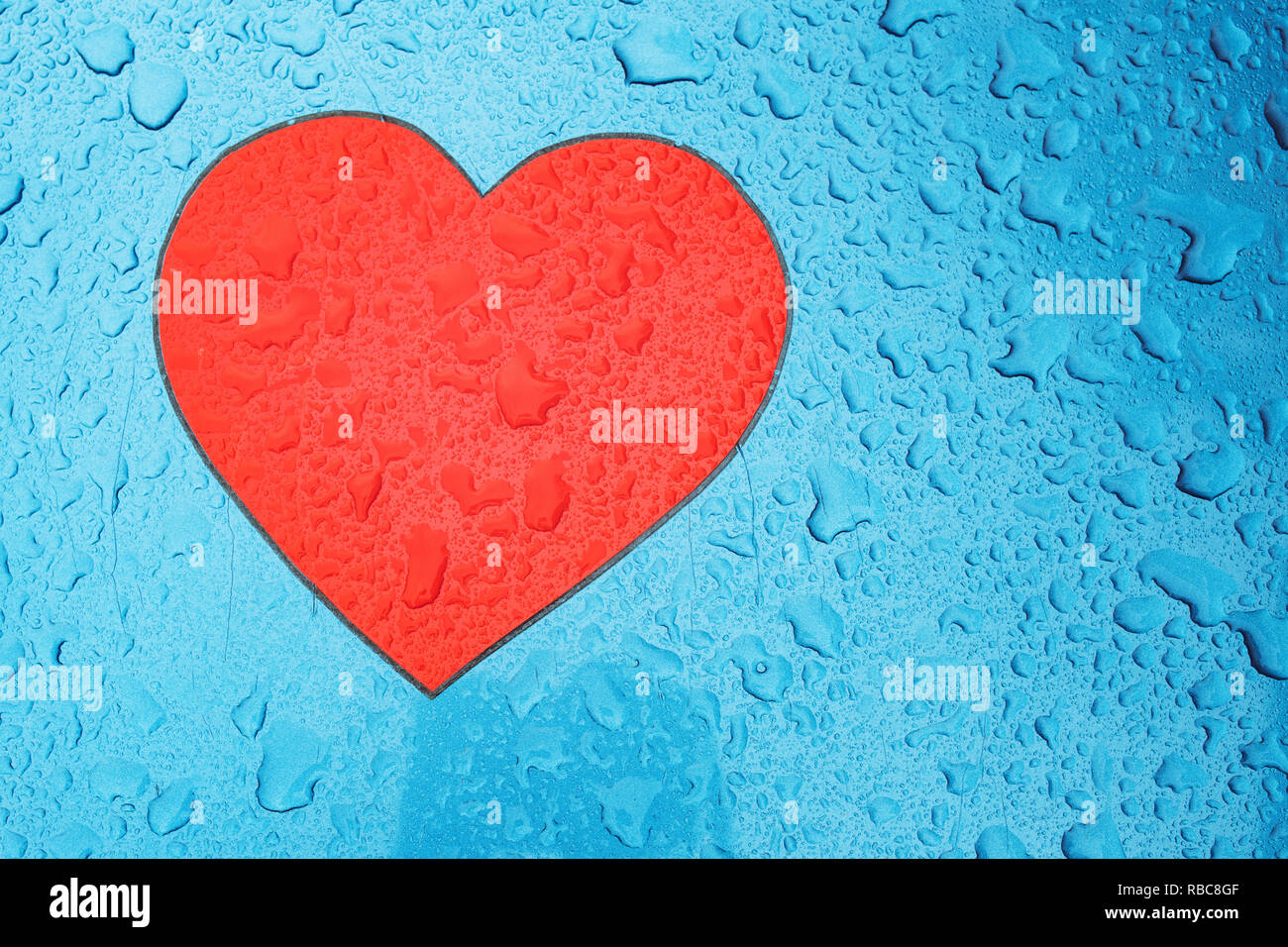 Heart shape symbol and raindrops on metal surface, love and romance ...