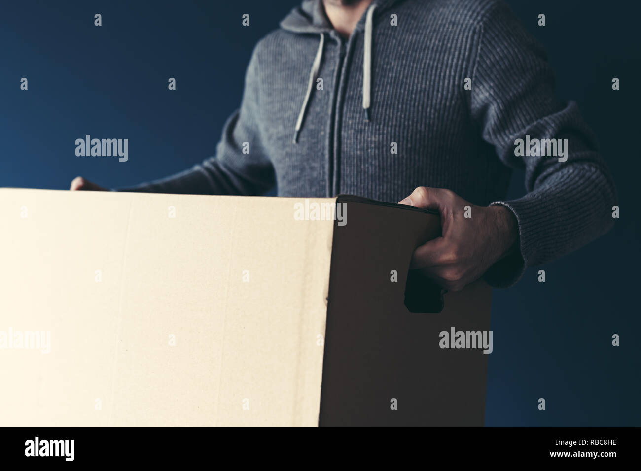 Packing and moving home, man holding large cardboard box Stock Photo ...