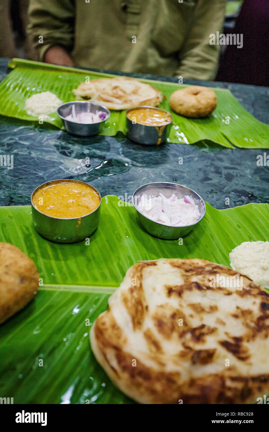 Traditional Indian lunch food served on green coconut leaf Stock Photo ...