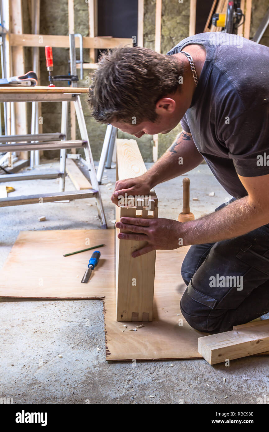 Carpenter makes new window for building project Stock Photo - Alamy