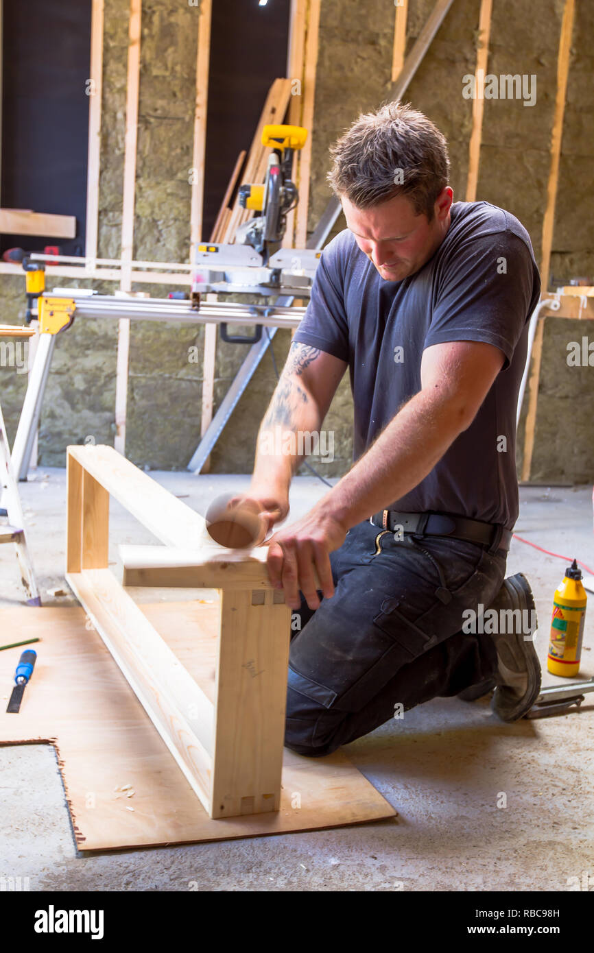 Carpenter makes new window for building project Stock Photo - Alamy