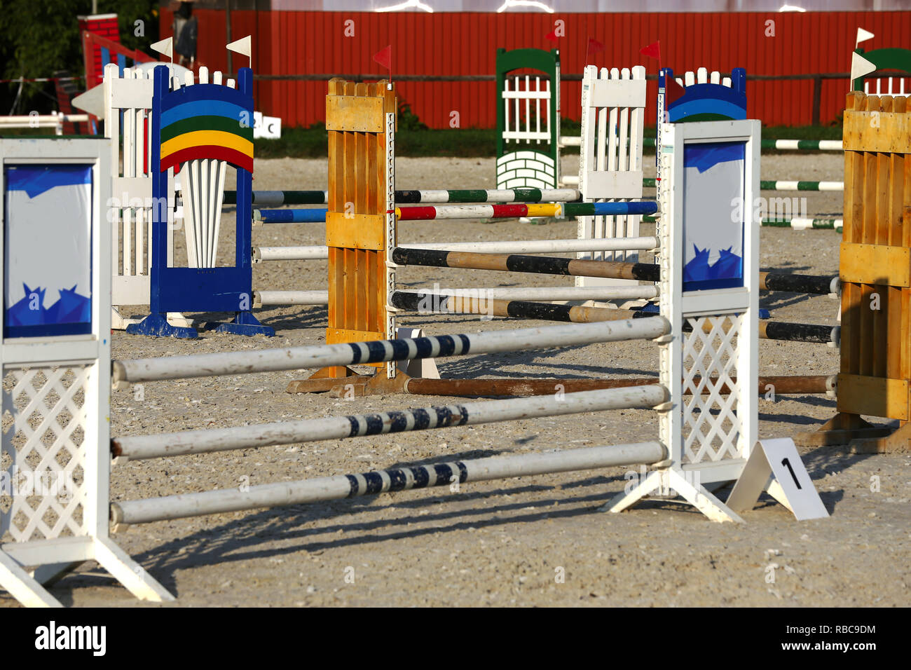 Colorful photo of equestrian obstacles. Empty field for horse jumping ...