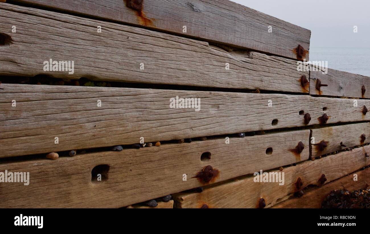 Rustic wooden groynes hi-res stock photography and images - Alamy