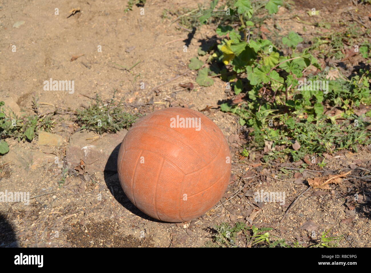 Old ball of football, of orange color, with which the children were ...