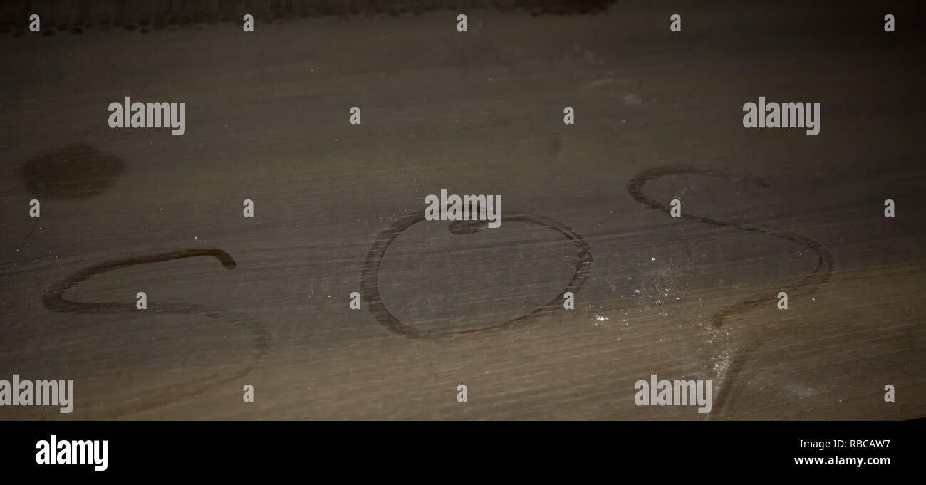 SOS symbol on table wood, help and danger Stock Photo - Alamy