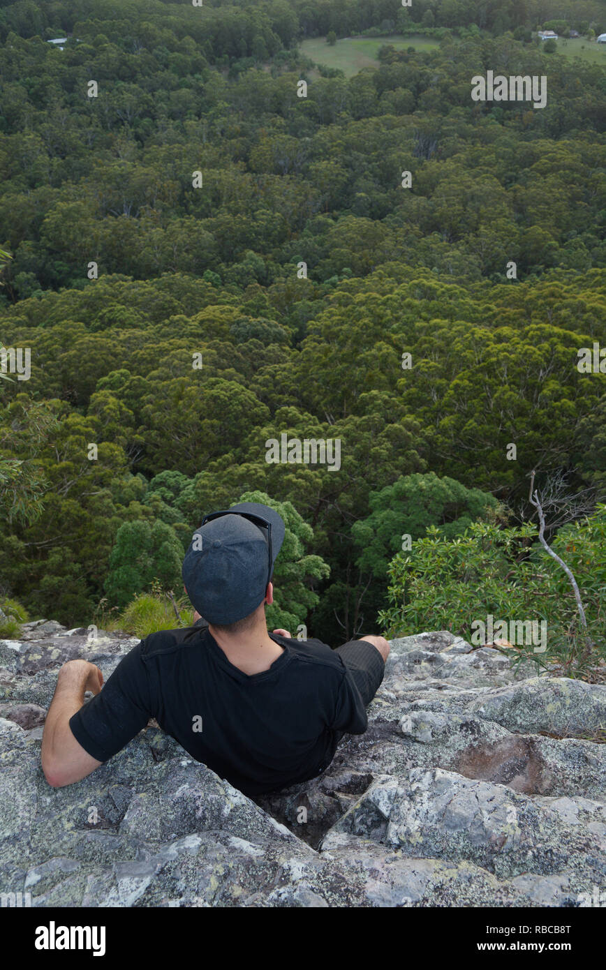 Person sitting cliff edge hi-res stock photography and images - Alamy