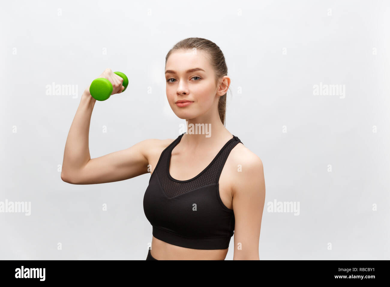 Happy fitness woman lifting dumbbells smiling cheerful, fresh and ...