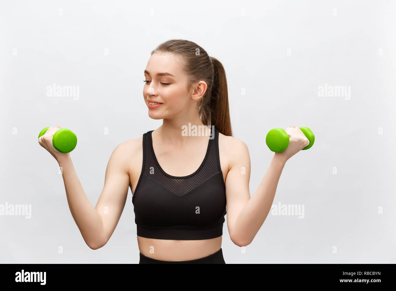 Happy fitness woman lifting dumbbells smiling cheerful, fresh and ...