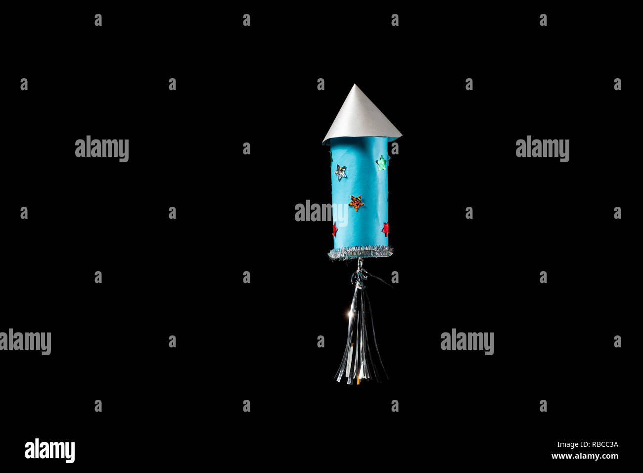 A rocket made of toilet paper roll by a child, black background Stock ...